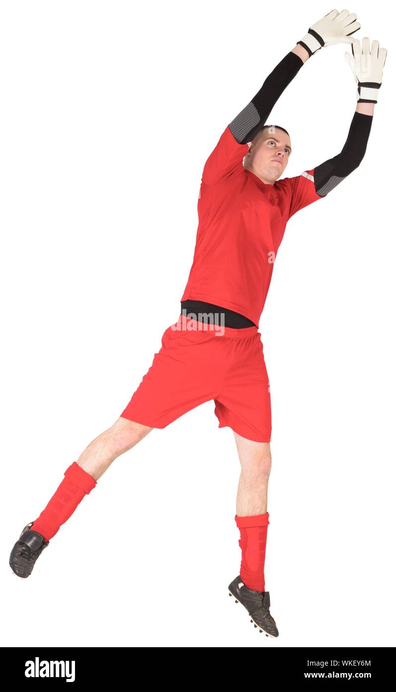 Fit goal keeper jumping up on white background Stock Photo - Alamy