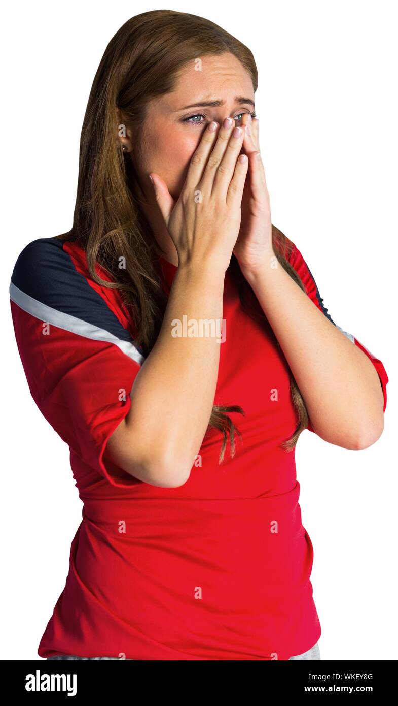 Pretty football fan looking nervous on white background Stock Photo - Alamy