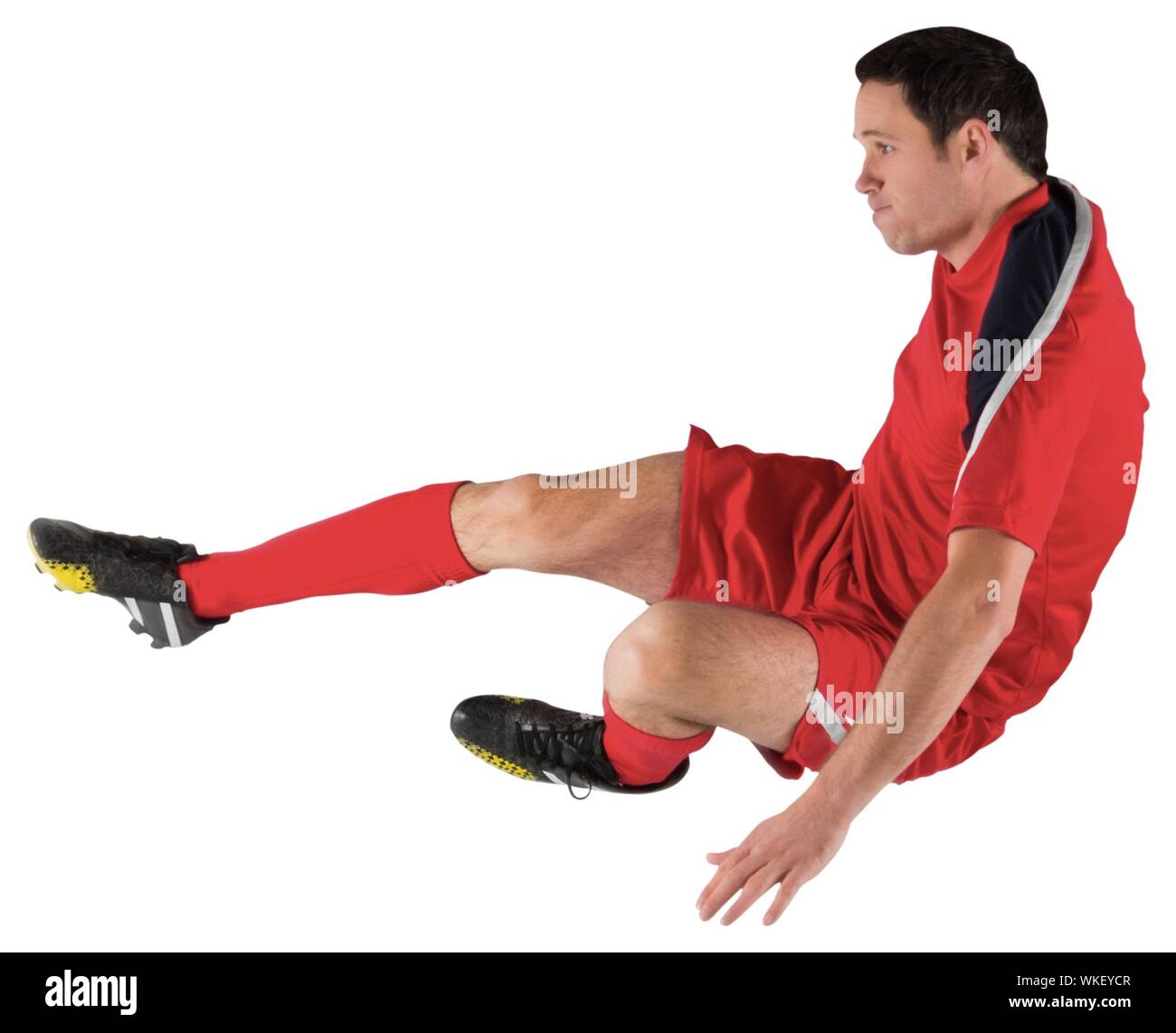 Football player in red kicking on white background Stock Photo - Alamy
