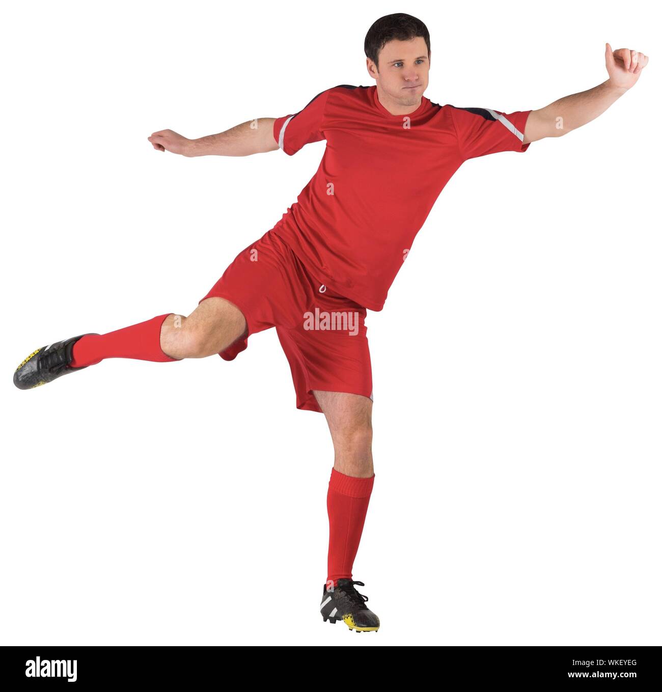 Football player in red kicking on white background Stock Photo - Alamy