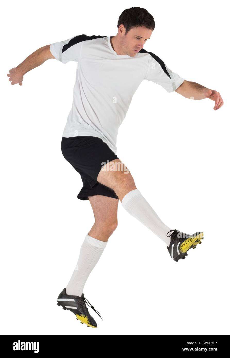 Football player in white kicking on white background Stock Photo - Alamy