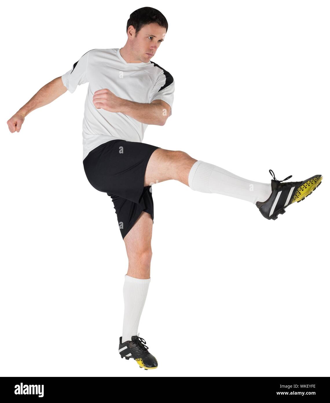 Football player in white kicking on white background Stock Photo - Alamy