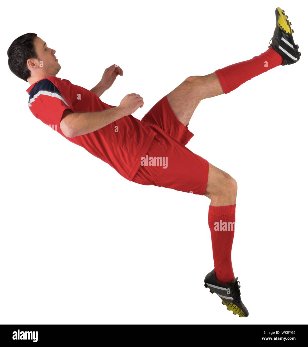 Football player in red kicking on white background Stock Photo - Alamy