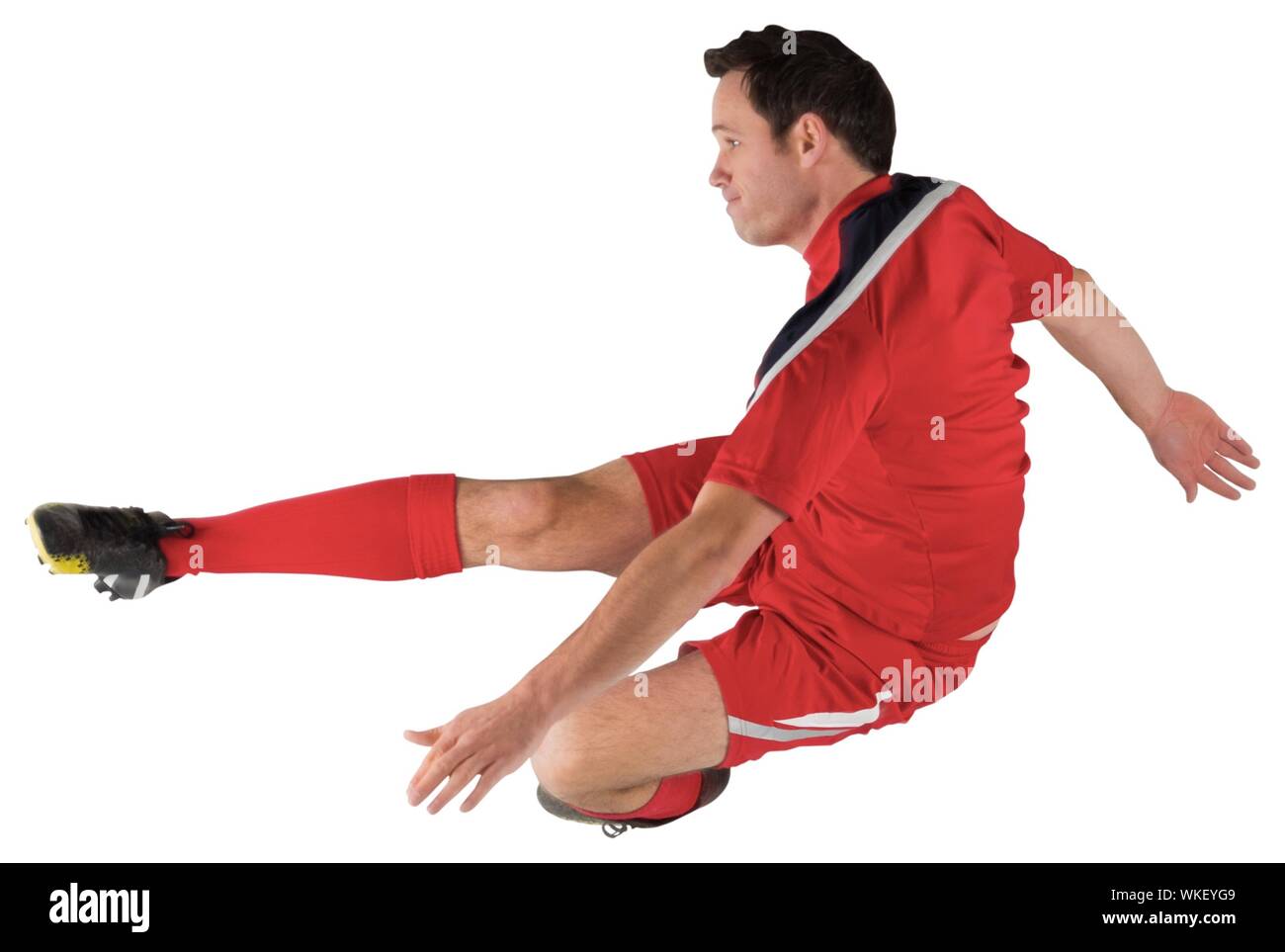 Football player in red kicking on white background Stock Photo - Alamy