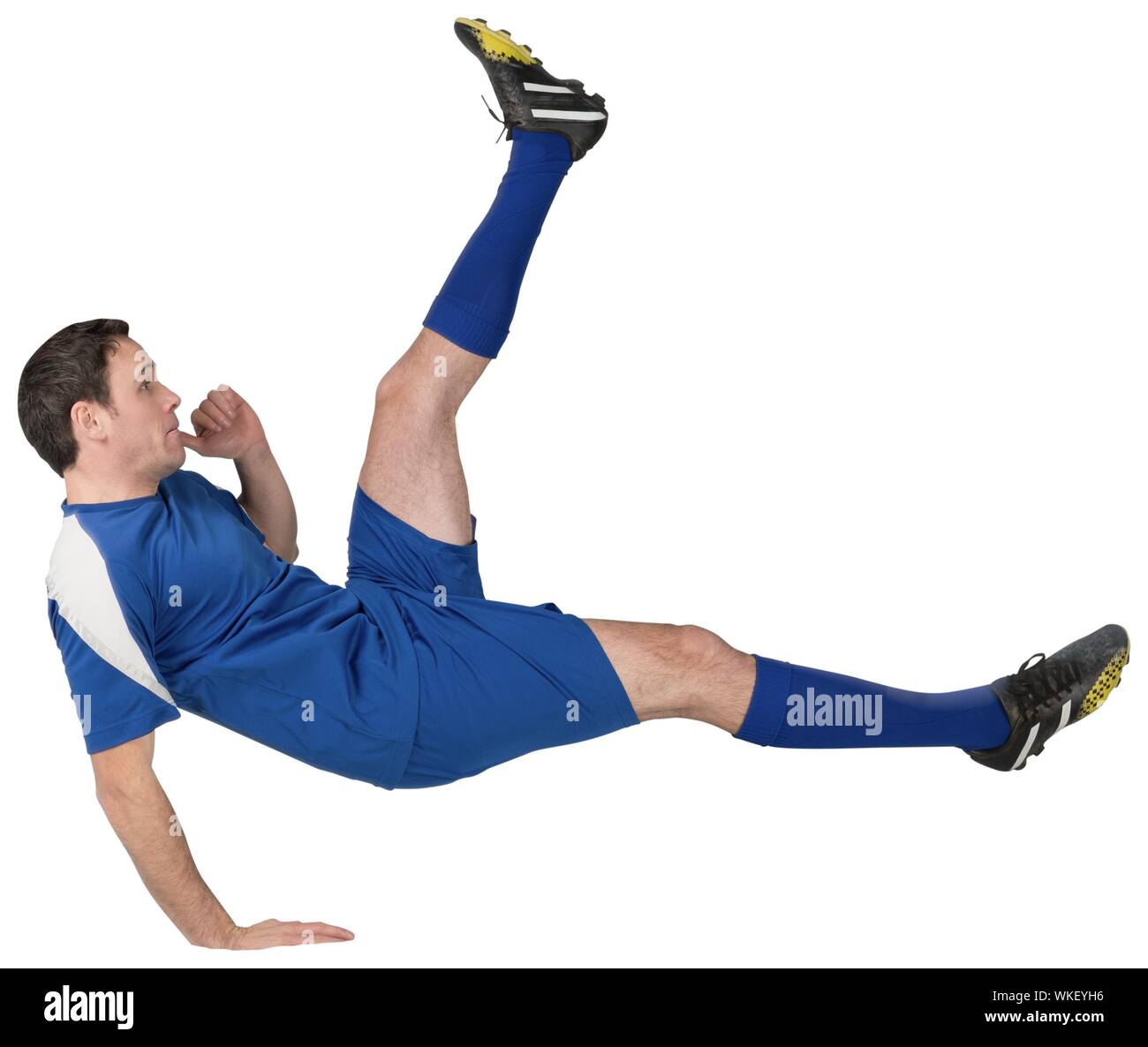 Football player in blue kicking on white background Stock Photo - Alamy
