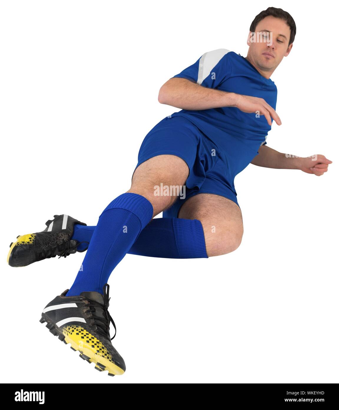 Football player in blue kicking on white background Stock Photo - Alamy