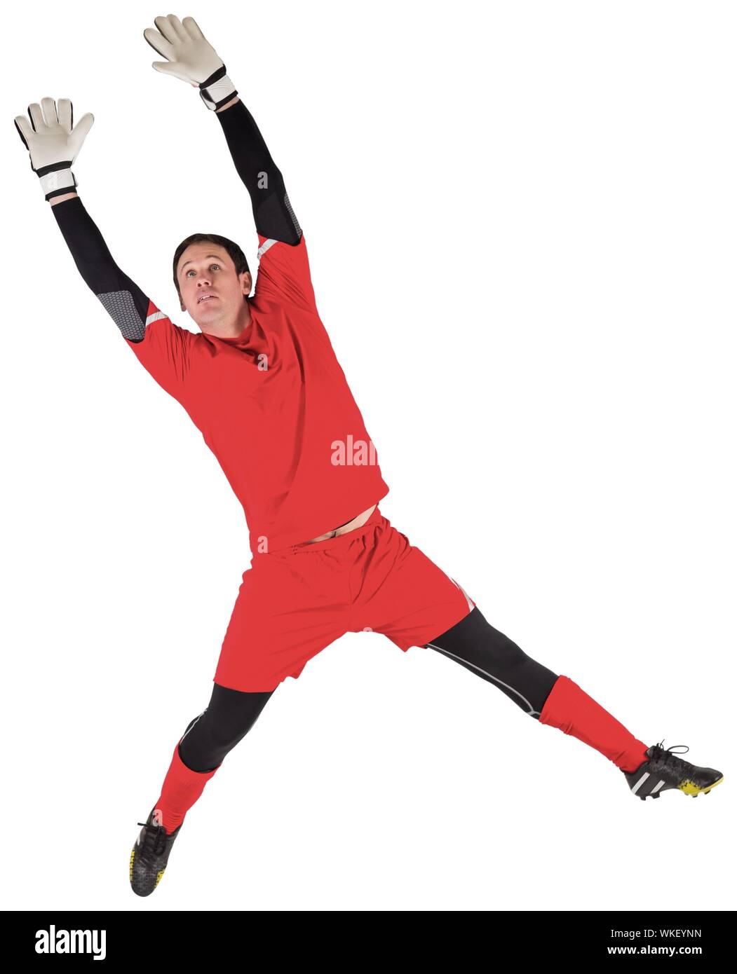 Fit goal keeper jumping up on white background Stock Photo - Alamy