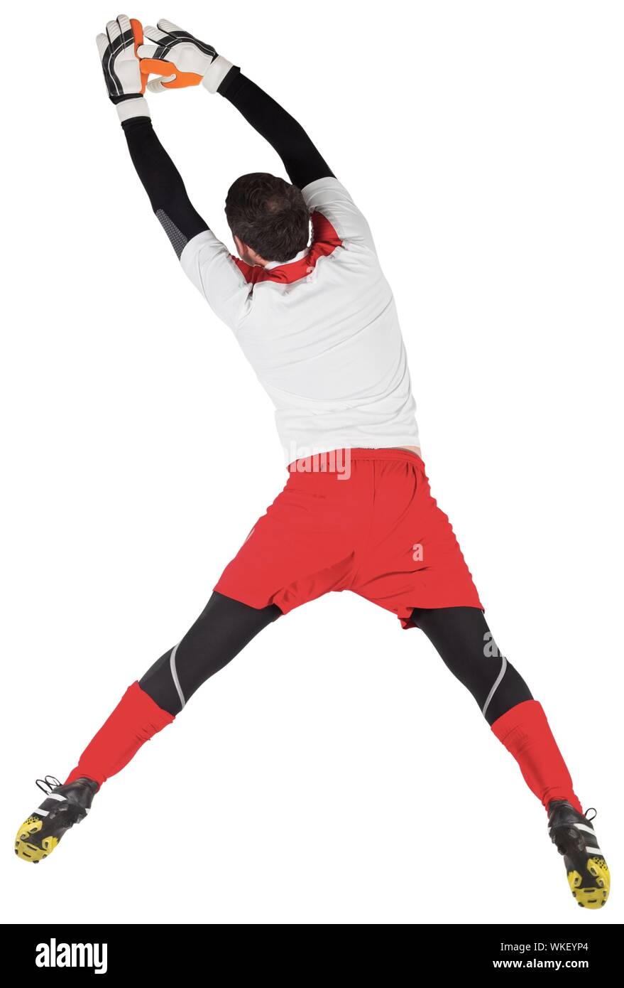 Fit goal keeper jumping up on white background Stock Photo - Alamy