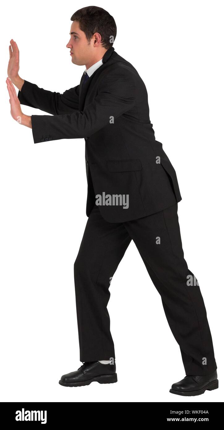 Young businessman standing and pushing on white background Stock Photo ...