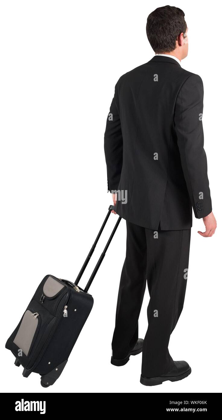 Young businessman pulling his suitcase on white background Stock Photo ...