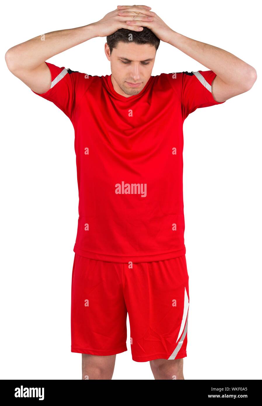 Disappointed football player looking down on white background Stock ...