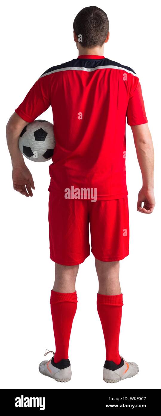 Football player wearing red gear standing with ball on white background ...