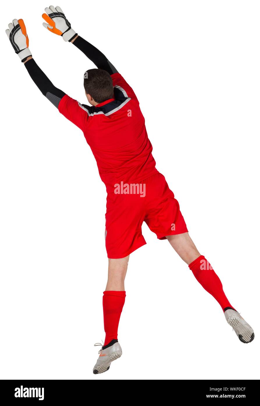 Fit goal keeper jumping up on white background Stock Photo - Alamy