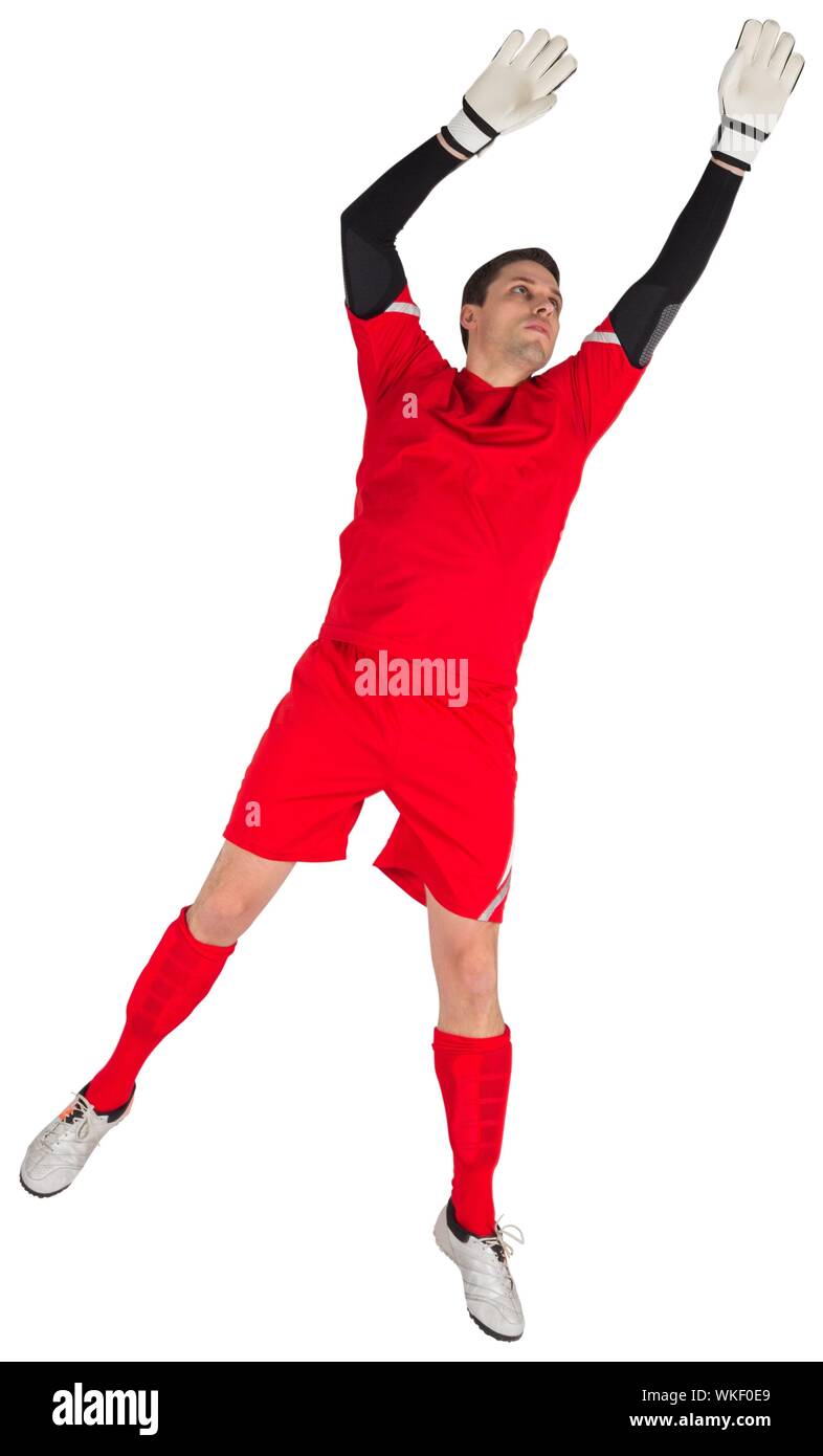 Fit goal keeper jumping up on white background Stock Photo - Alamy
