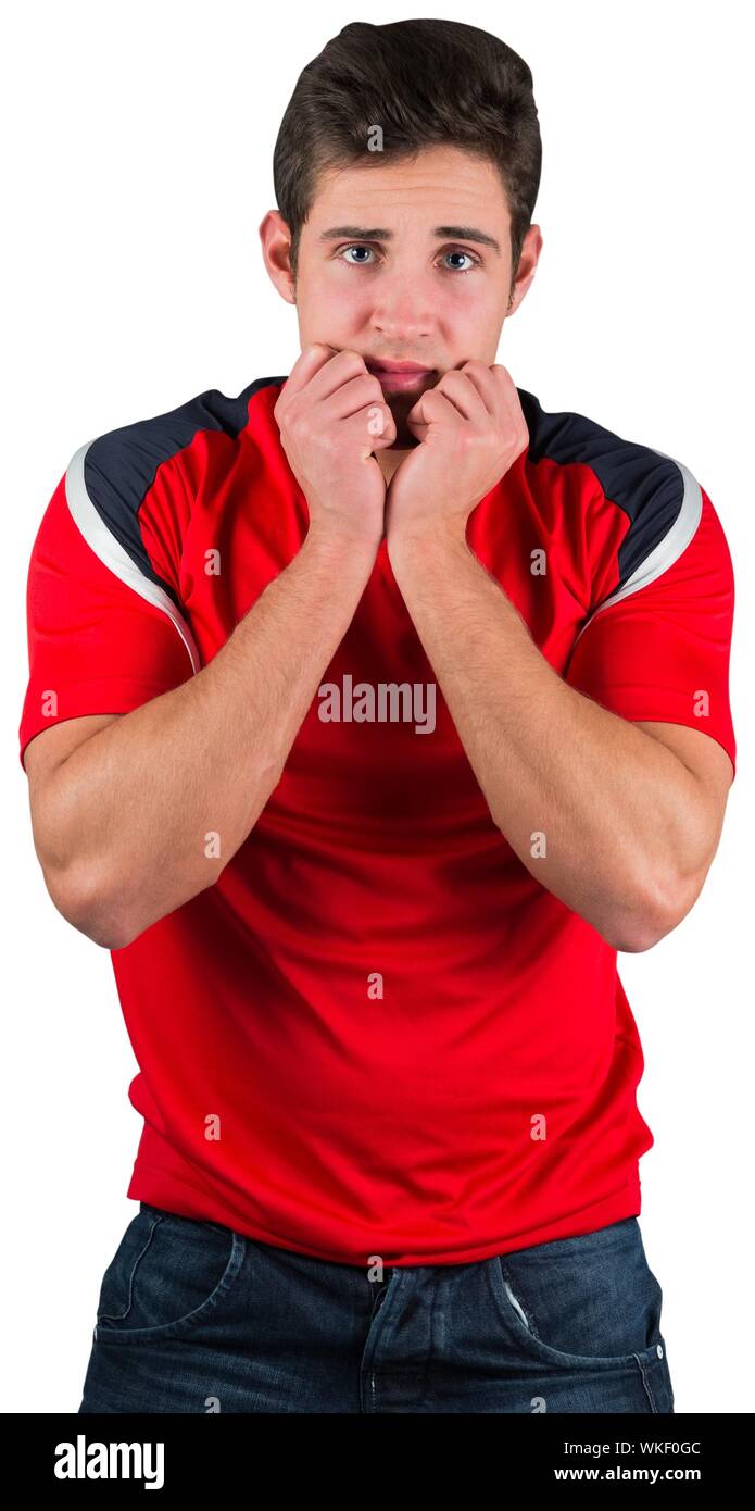 Nervous football fan in red on white background Stock Photo - Alamy