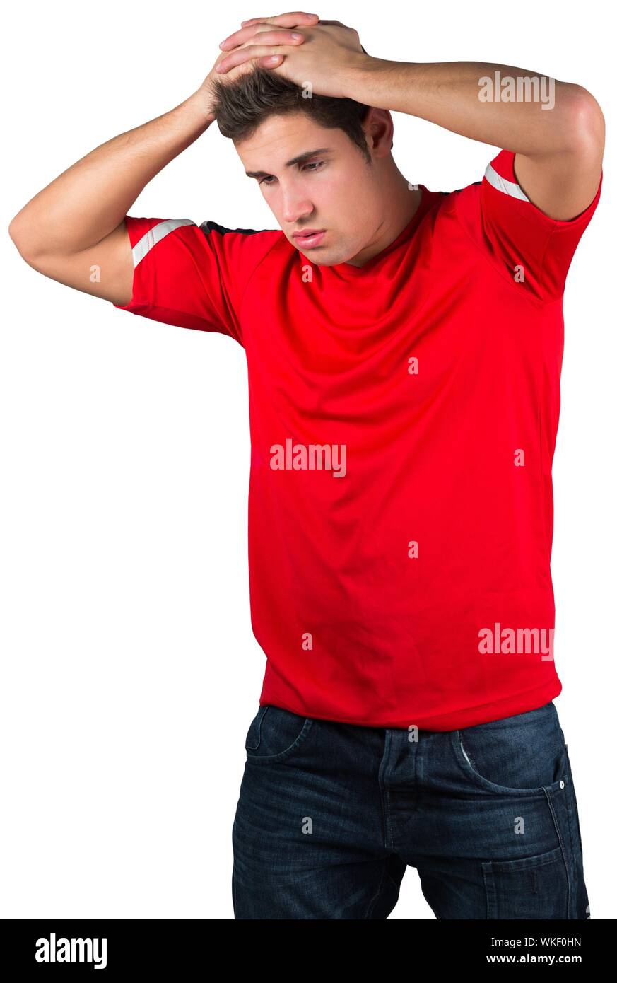 Disappointed football fan in red on white background Stock Photo - Alamy