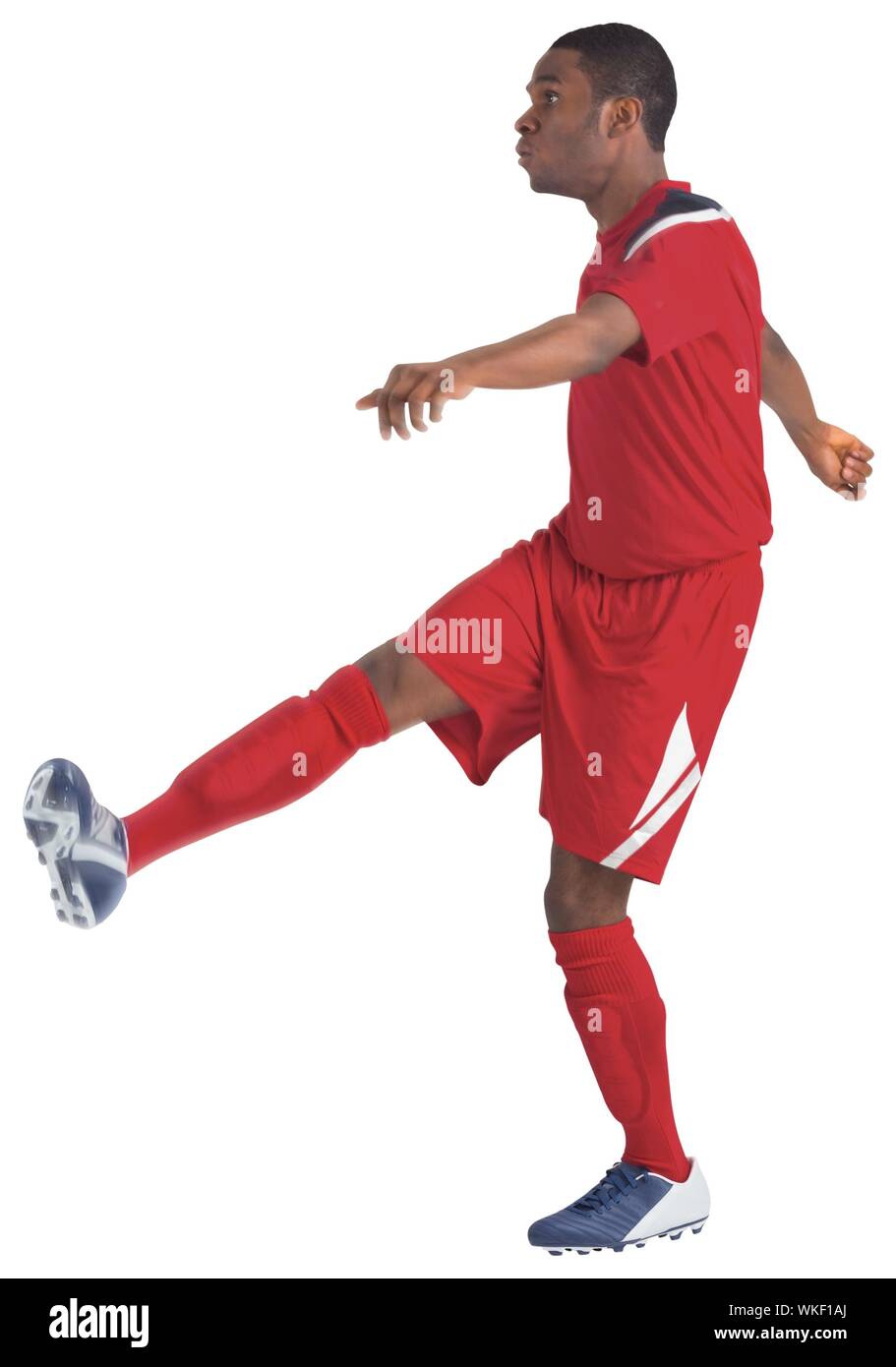 Football player in red kicking on white background Stock Photo - Alamy