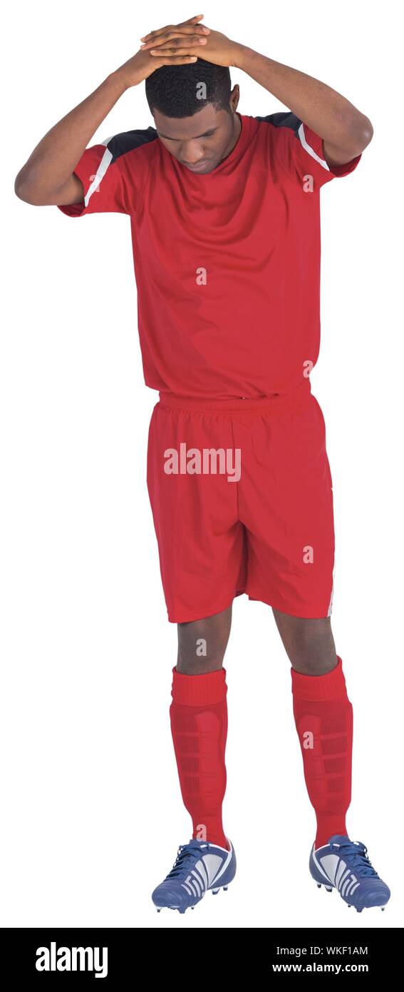 Disappointed football player looking down on white background Stock ...