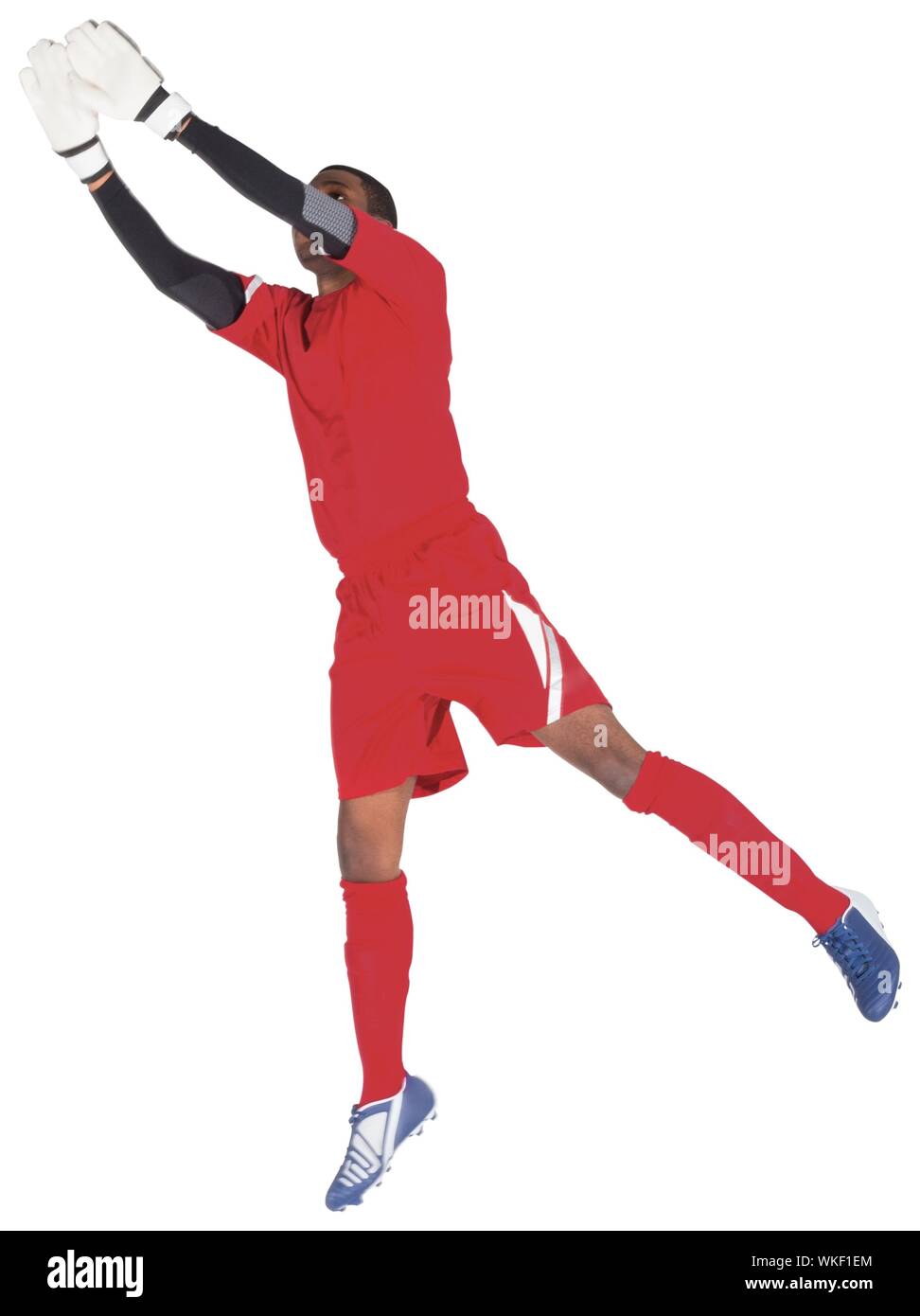 Goalkeeper in red making a save on white background Stock Photo - Alamy