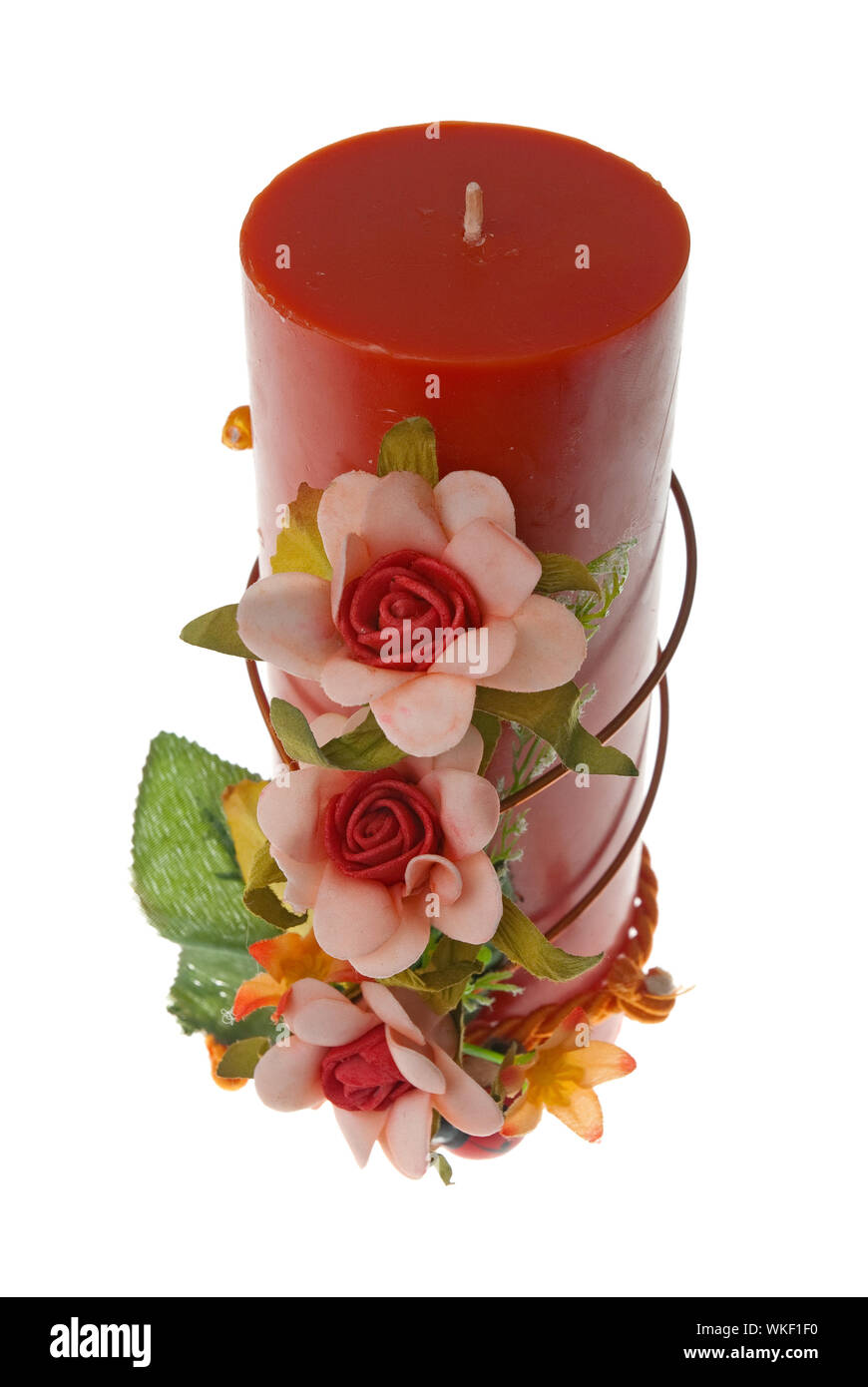 Large red candle with the flower decoration isolated on white ...