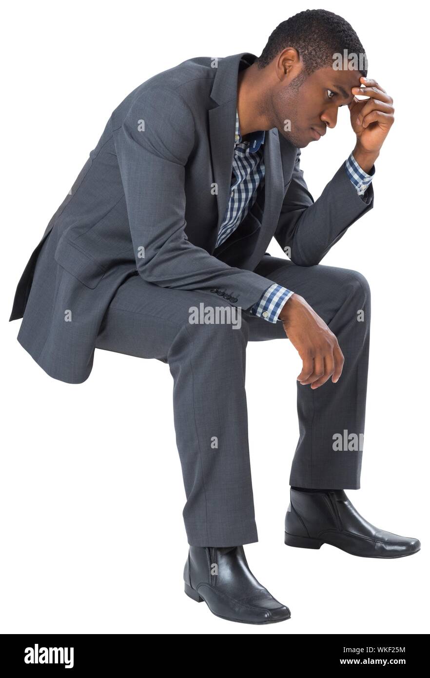 Thinking businessman sitting on white background Stock Photo - Alamy