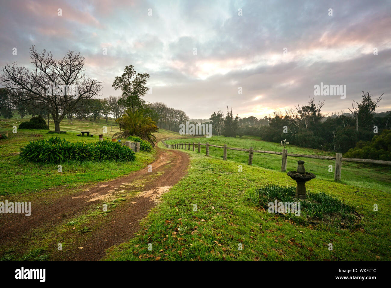 Landscape of a country farm land with a cottage at the background ...