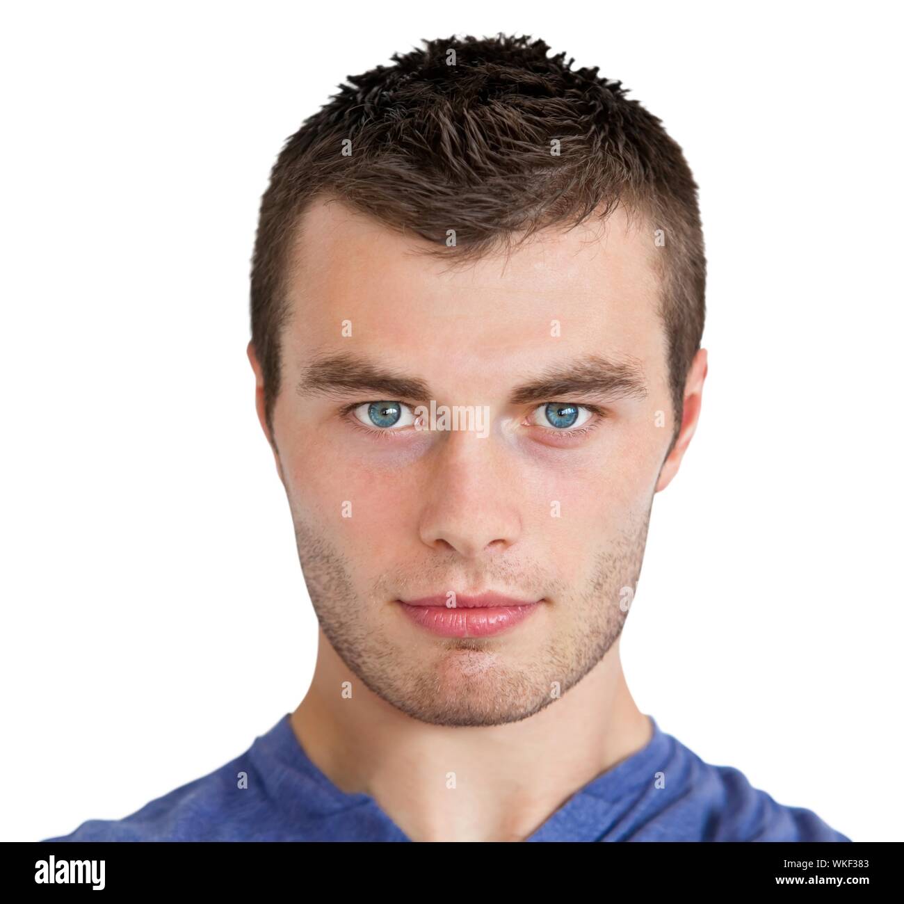 Serious young man looking at camera on white background Stock Photo - Alamy