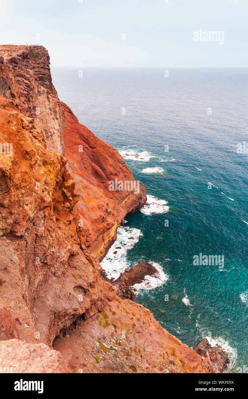Vertical landscape photo with shore water and red rocks of Ponta de Sao ...
