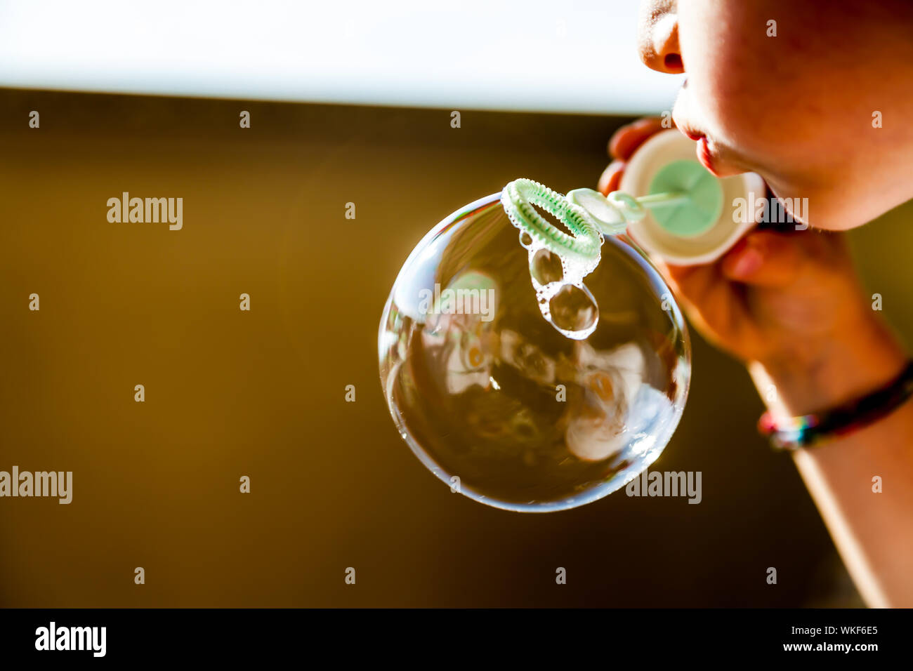 Hand holding bubble wand hi-res stock photography and images - Alamy