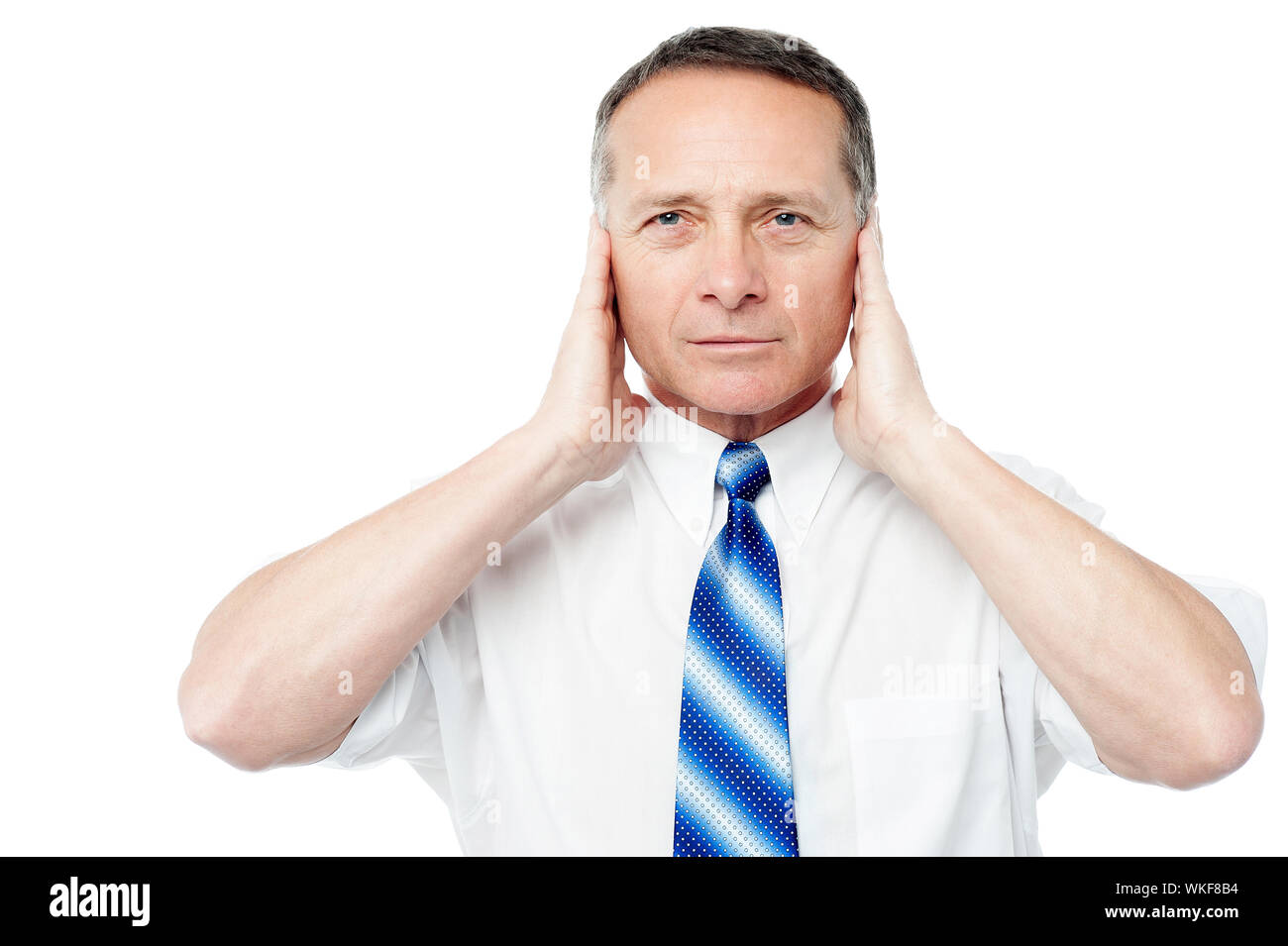 Man holding his hands up to his ears trying to mute Stock Photo - Alamy