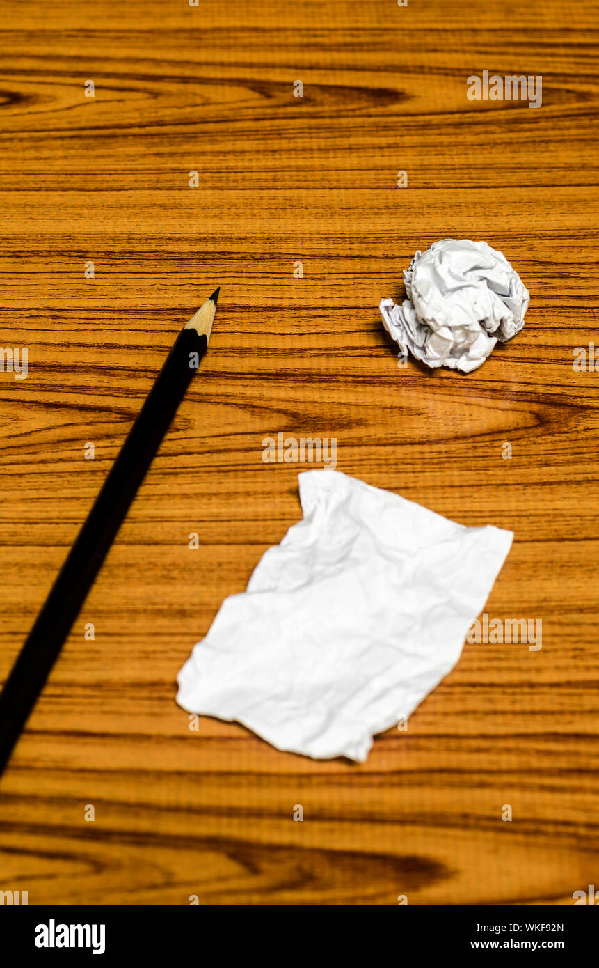 paper scrap and crumpled with pencil on wood background Stock Photo - Alamy