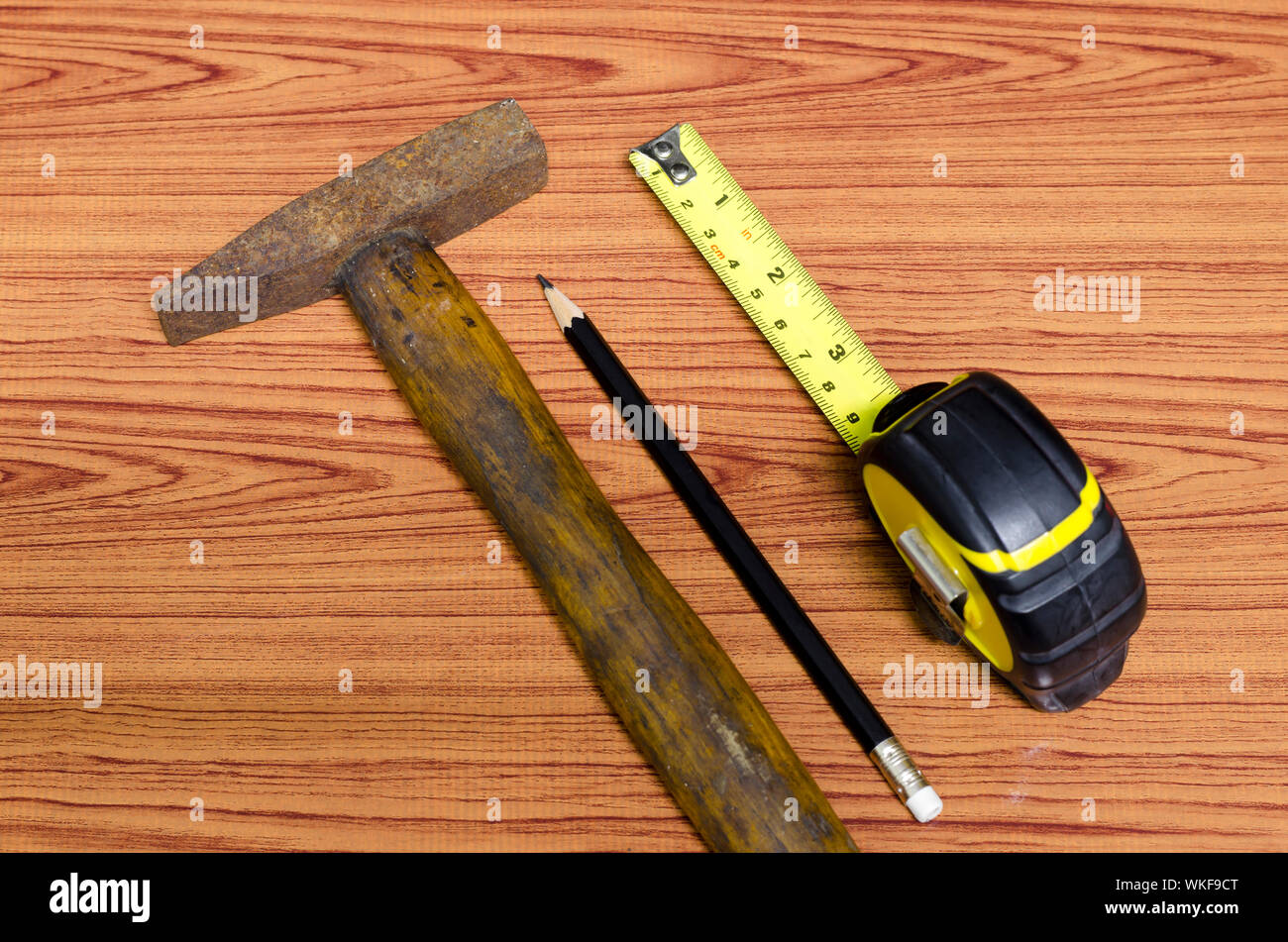 hammer measuring tape and pencil concept tools on wood background Stock ...