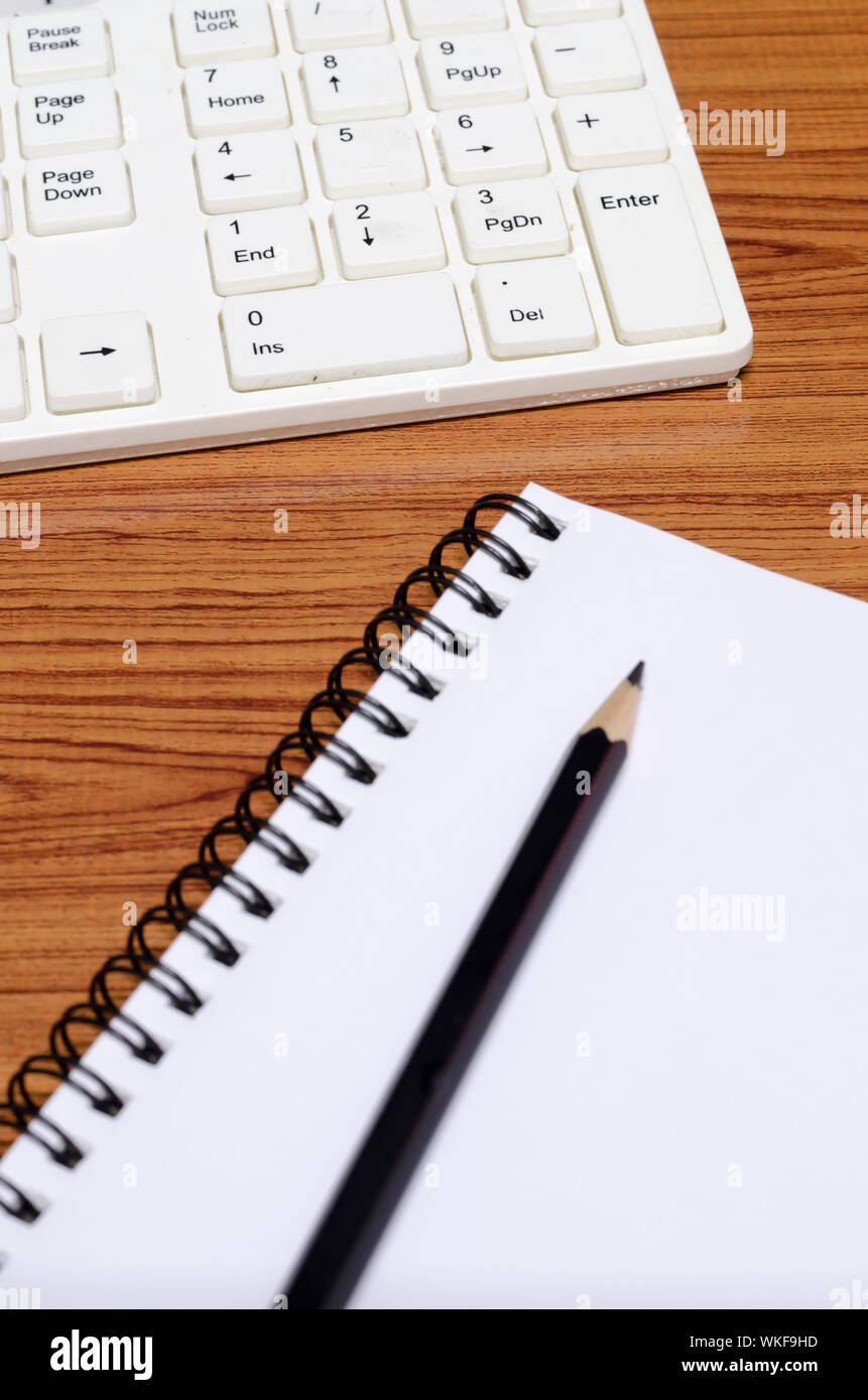 keyboard computer with notebook and pencil Stock Photo - Alamy