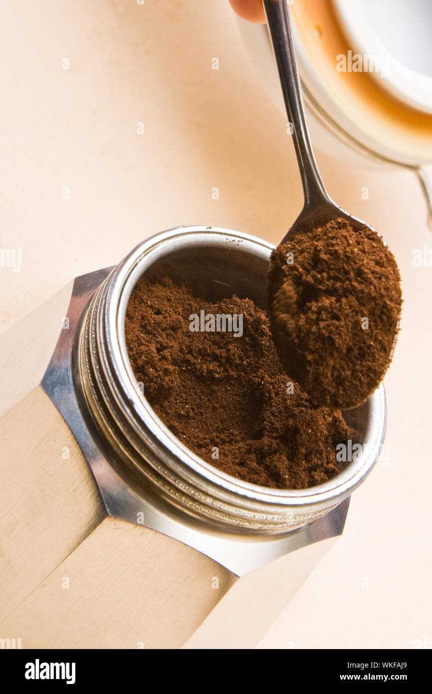 Putting the ground coffee powder into the filter Stock Photo - Alamy