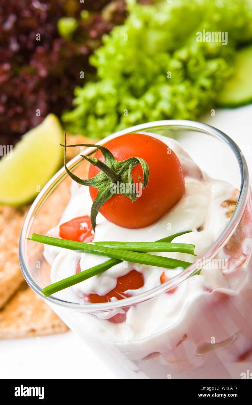 Glass of quark, yogurt and chopped tomatoes Stock Photo - Alamy