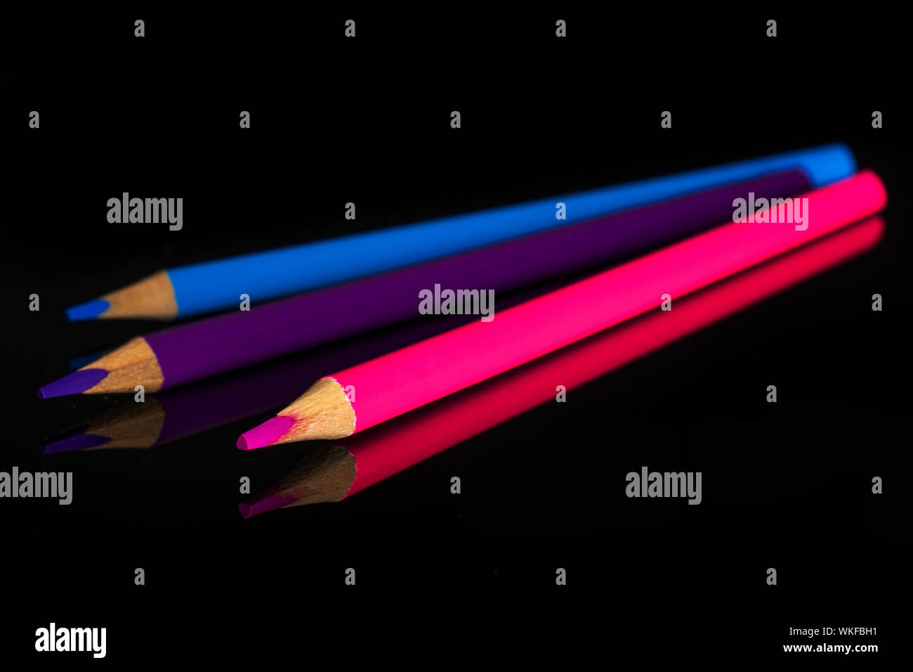 Group of three whole sharp colored pencil cold gamma isolated on black ...