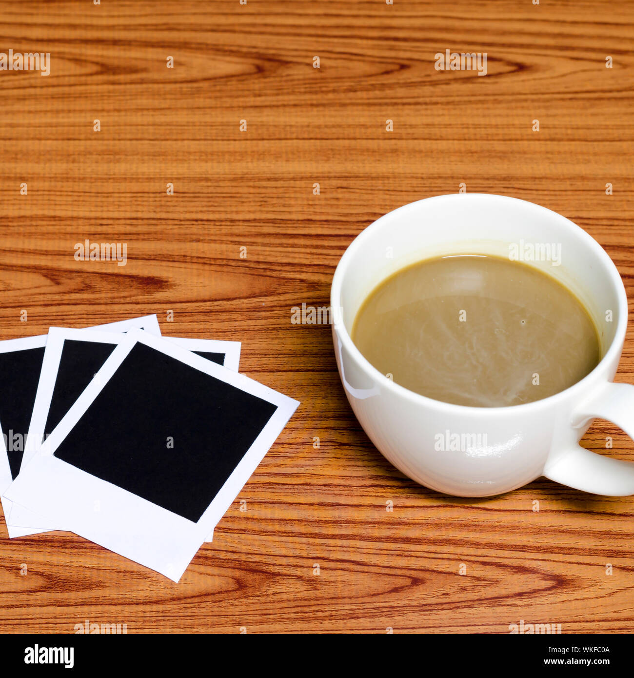 coffee cup with photo frame on wood background Stock Photo - Alamy