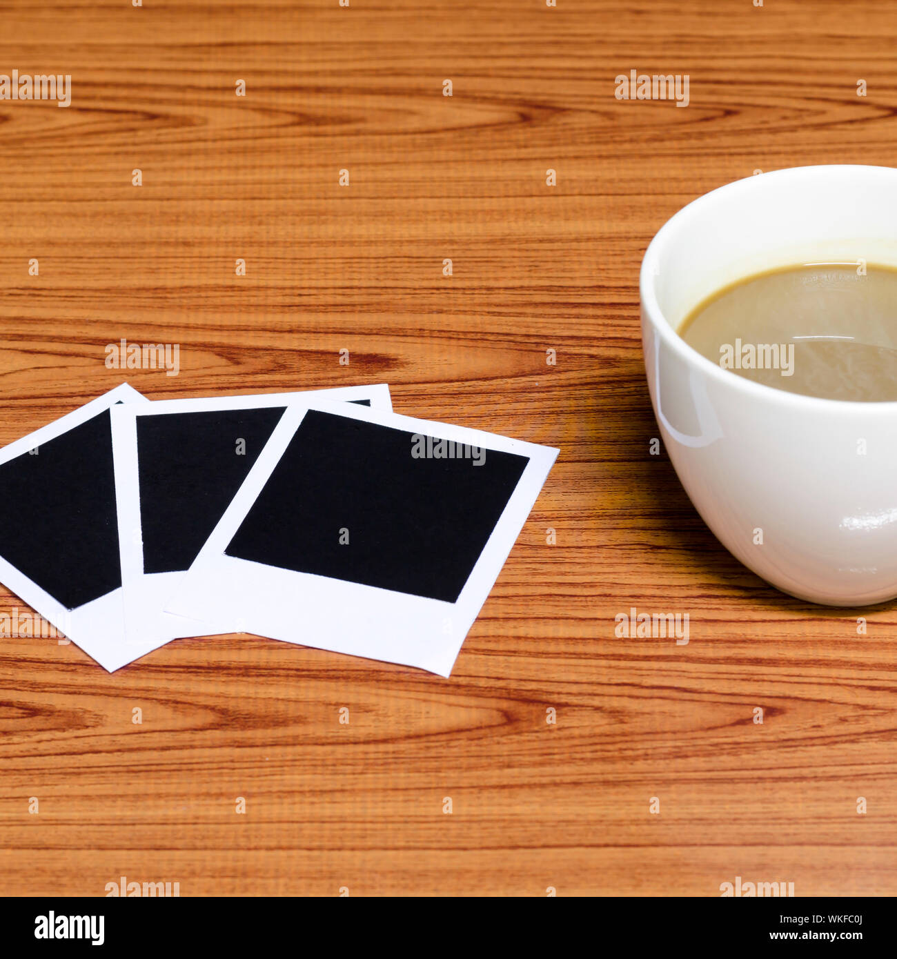 coffee cup with photo frame on wood background Stock Photo - Alamy