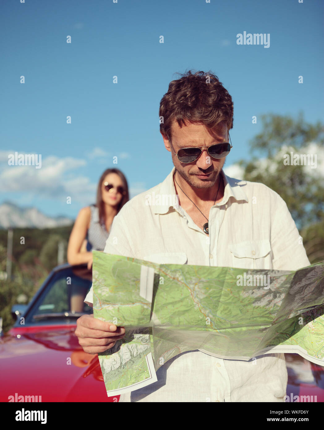 Beautiful couple trying to find their way Stock Photo - Alamy