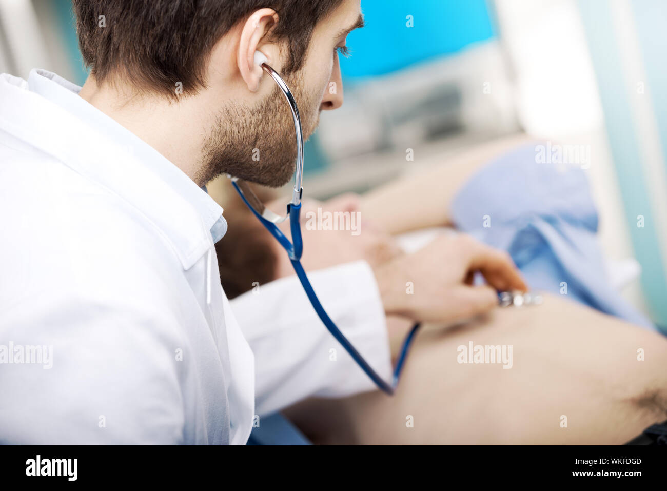 Doctor examining patient's heartbeat with a stethoscope Stock Photo - Alamy