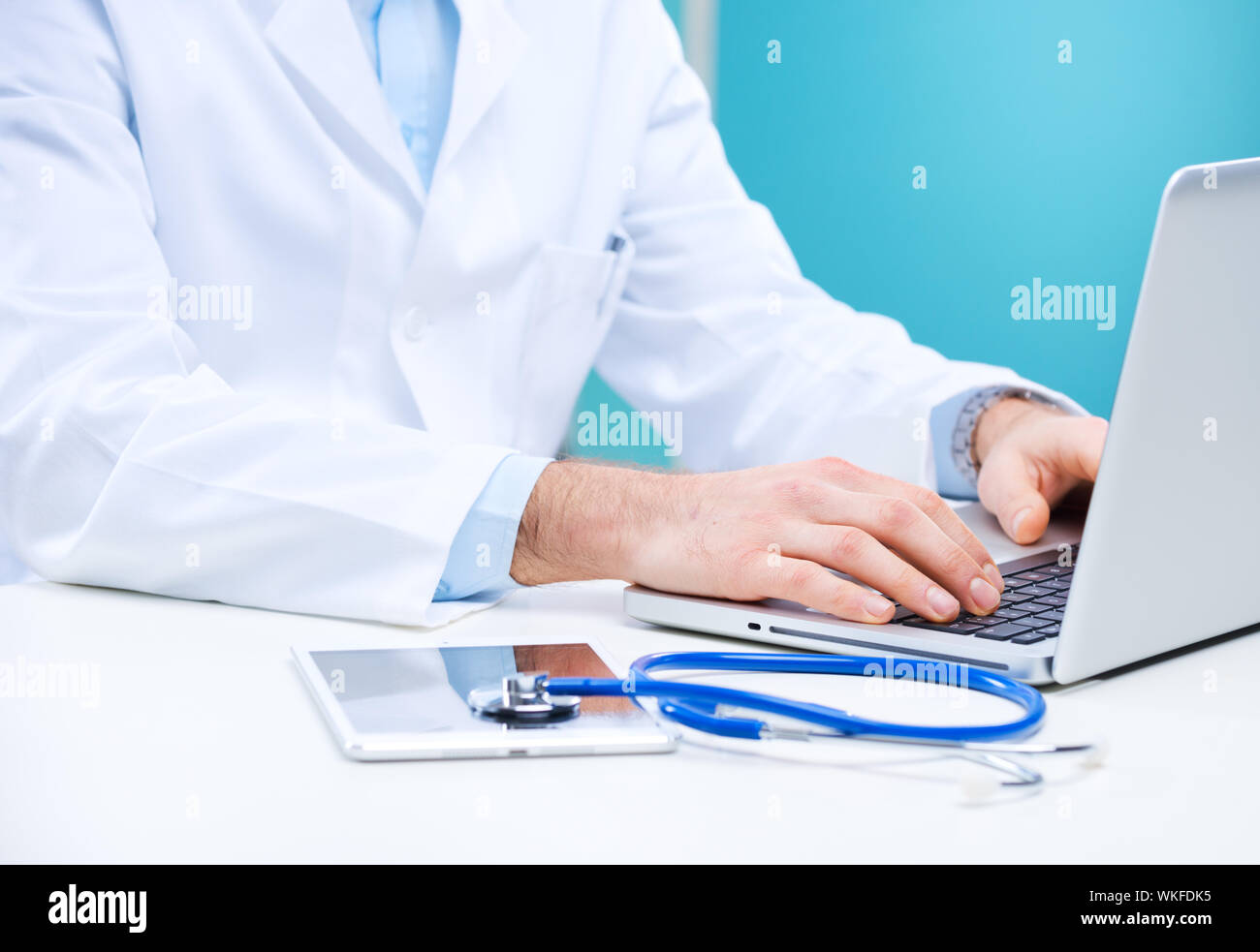 Doctor working at his desk with stethoscope, laptop and tablet Stock ...