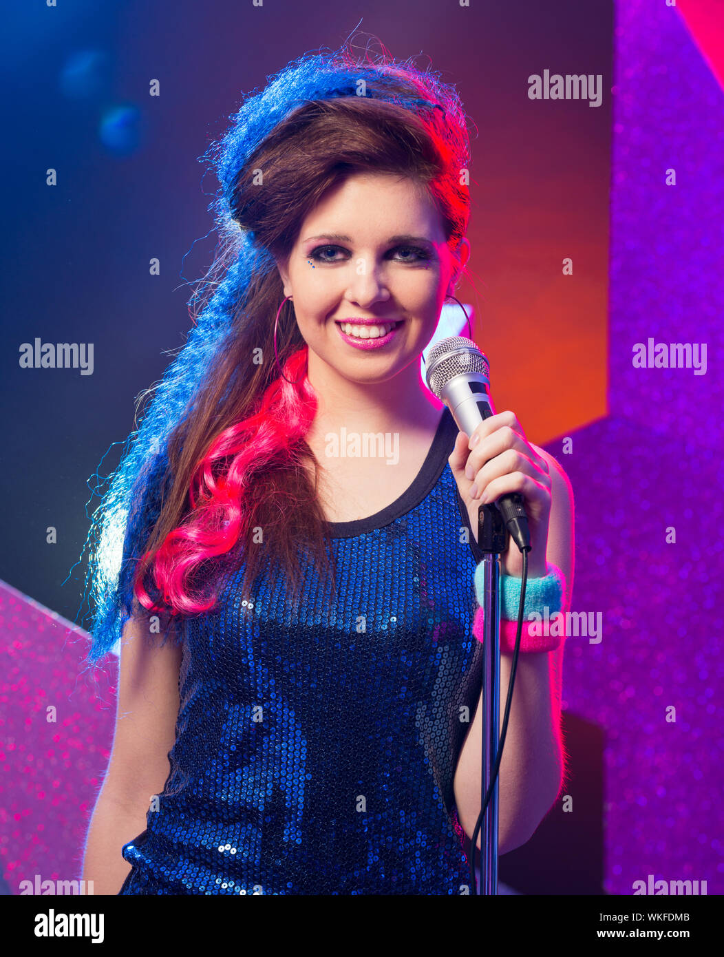 Young beautiful girl singing on stage with star on background Stock ...