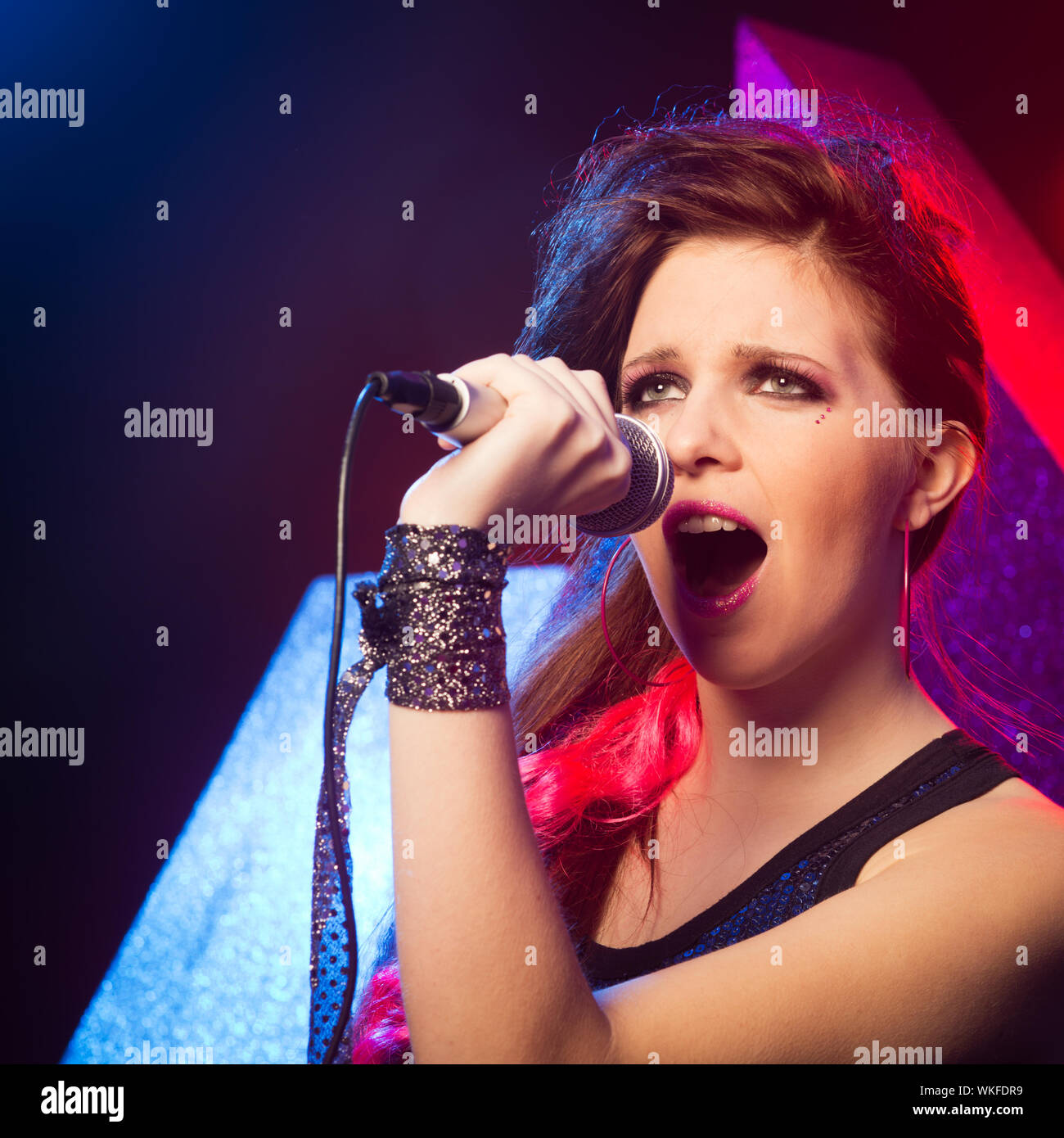 Young pop star girl singing on stage close up Stock Photo - Alamy