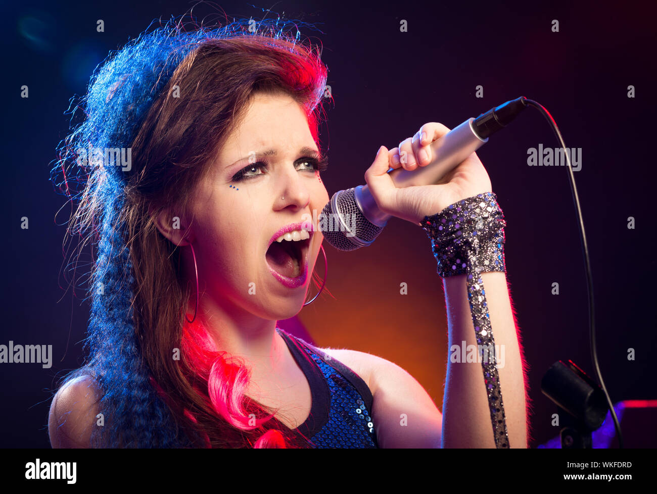 Young pop star girl singing on stage close up Stock Photo - Alamy