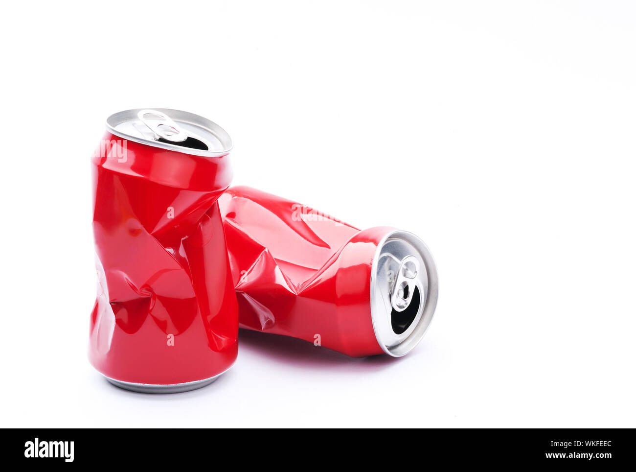 Red crushed cans on white background, recycling and pollution concept ...