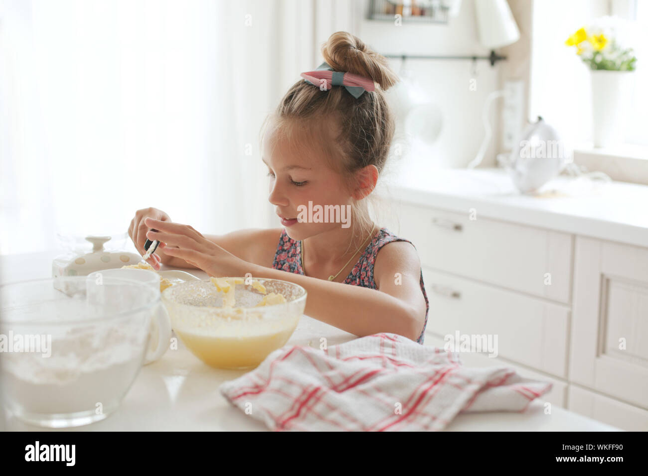 7 years old school girl cooking at the kitchen, casual lifestyle photo ...