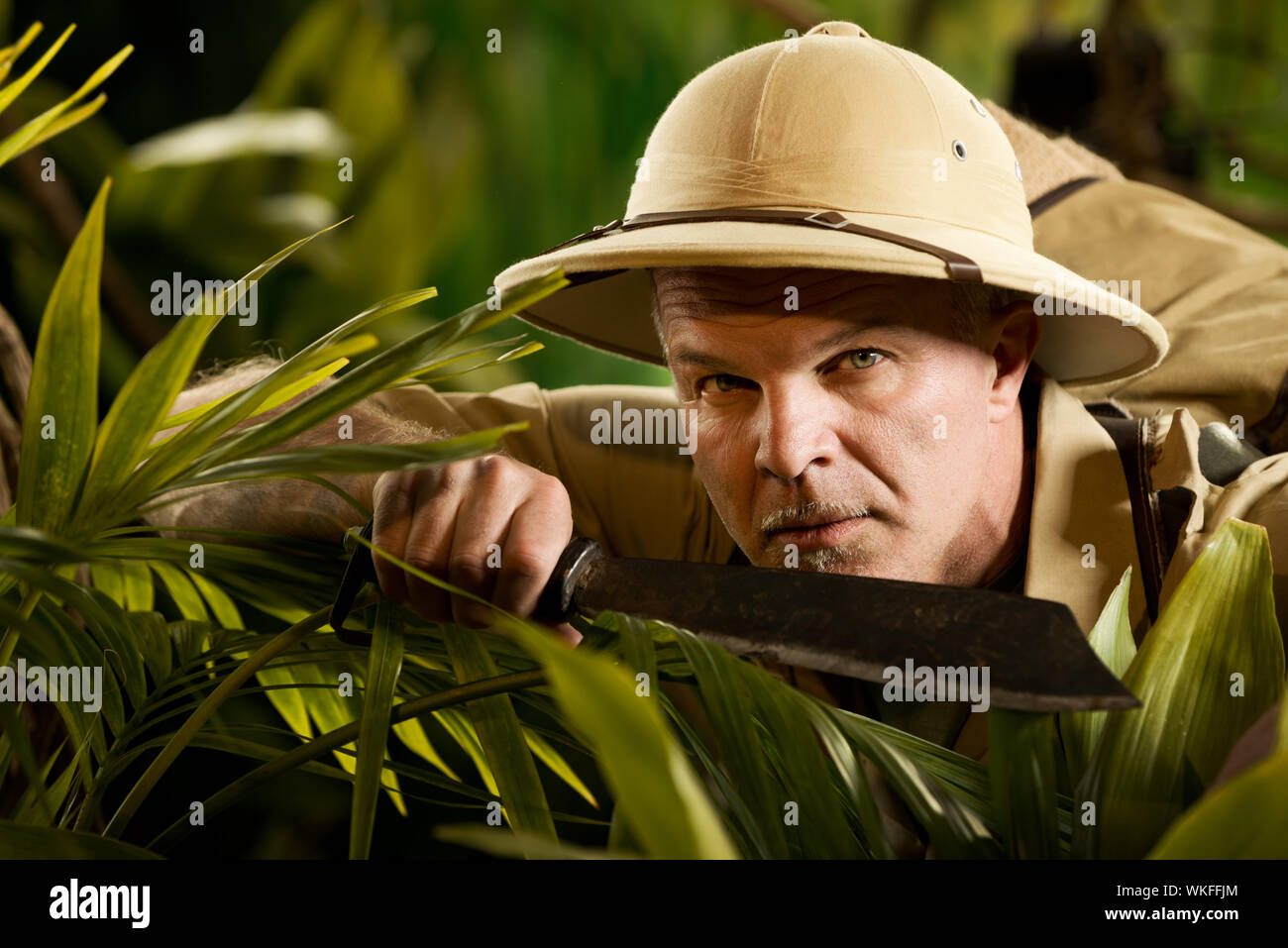 Survival confident adventurer exploring the rainforest jungle holding a ...