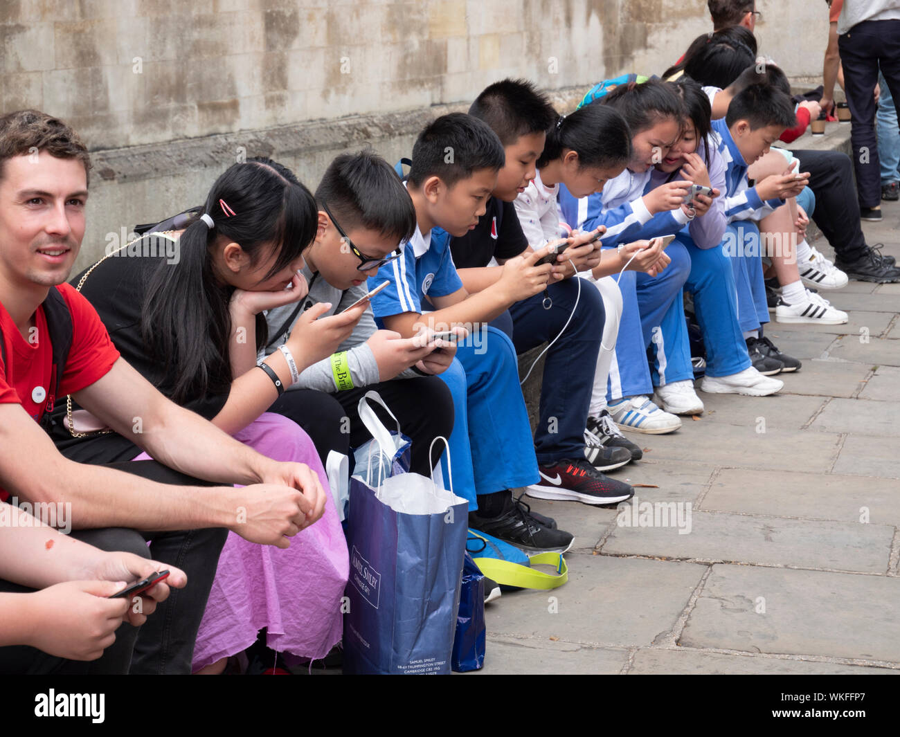 children, young people, looking at phone, looking at smartphone ...