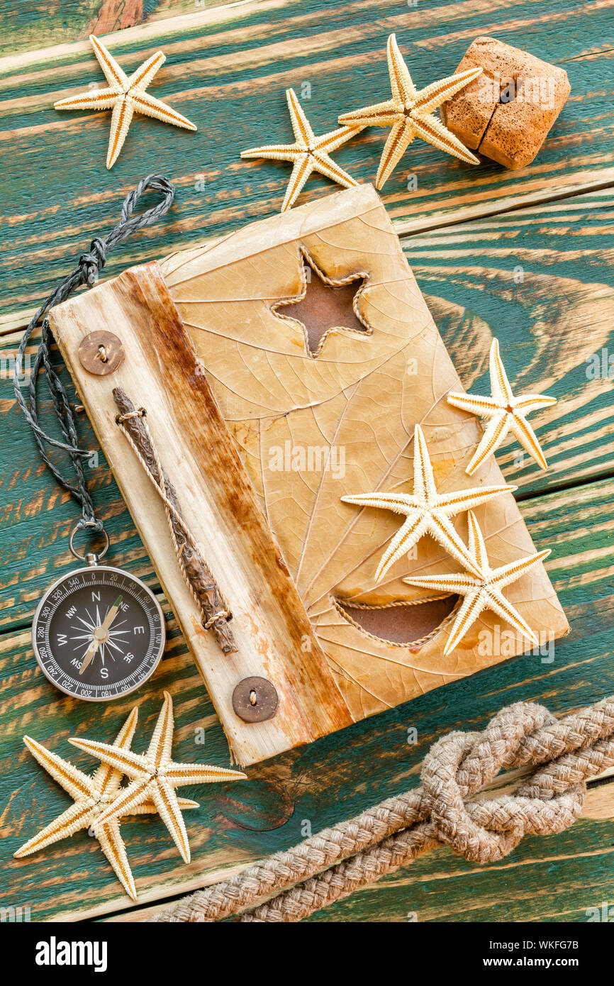 Old notepad with seashells on the deck Stock Photo - Alamy