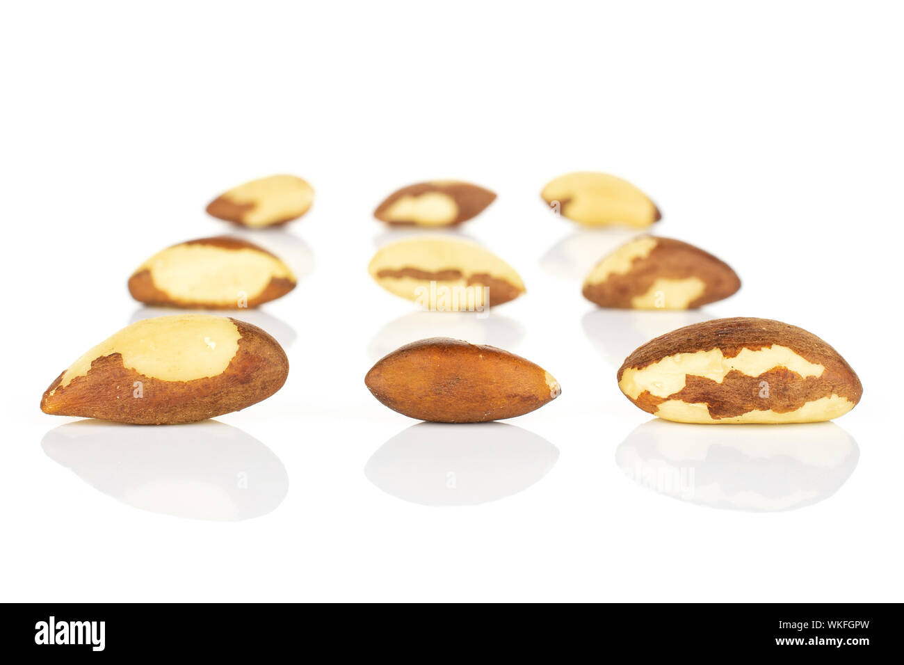 Group of nine whole raw brown brazil nut isolated on white background ...